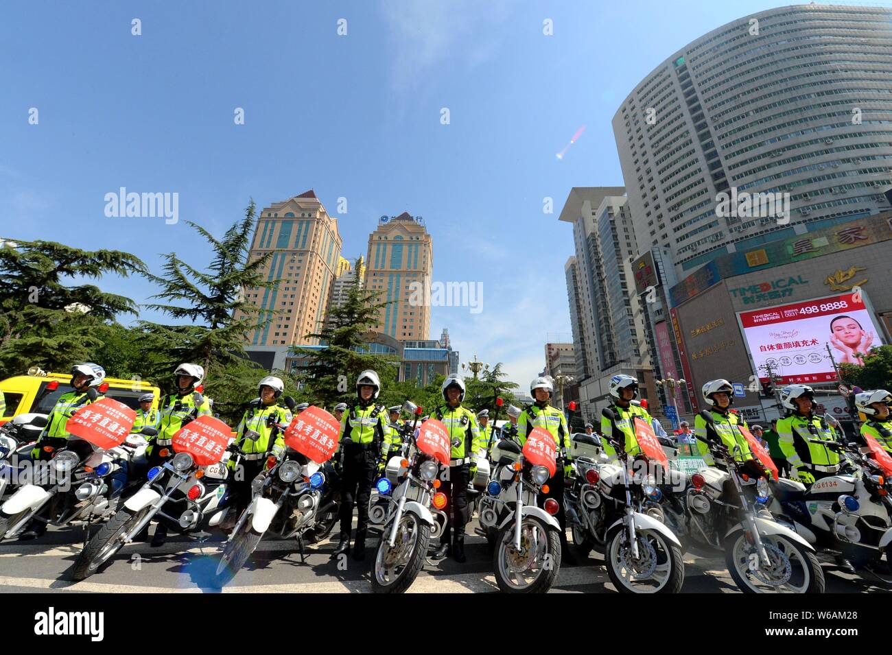 Chinese auxiliary traffic police officers pose with motorcycles during ...