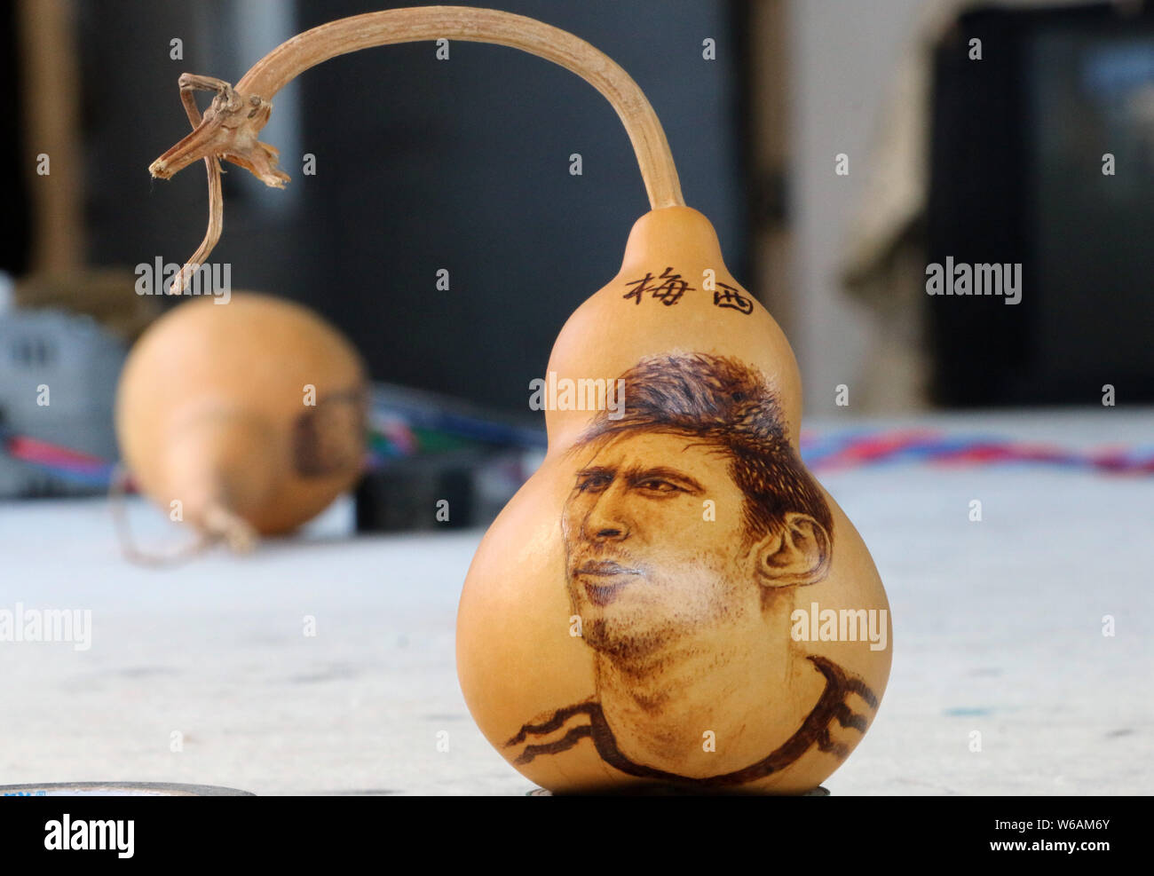 A calabash decorated with a picture of Argentine football player Lionel ...
