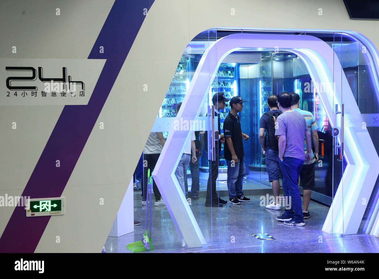 Customers shop at a 24-hour unmanned convenience store at the People's ...