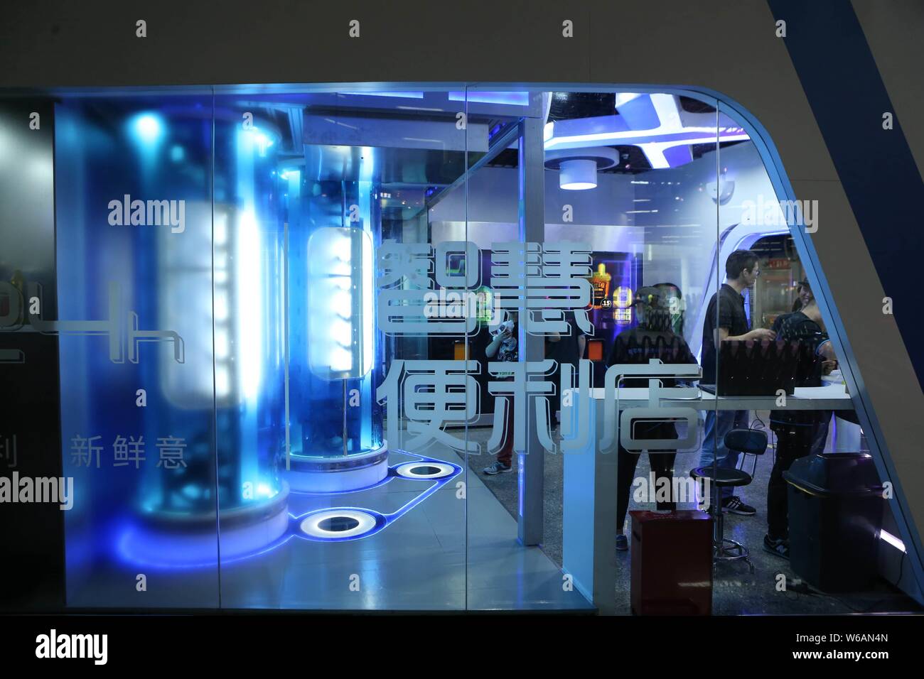 Customers shop at a 24-hour unmanned convenience store at the People's ...