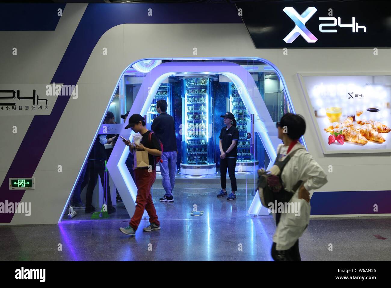 Customers shop at a 24-hour unmanned convenience store at the People's ...