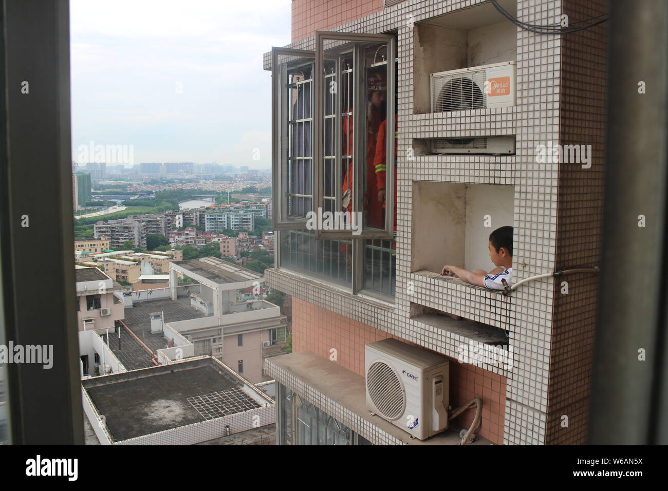 Chinese firefighters prepare to rescue a naughty boy after he got ...