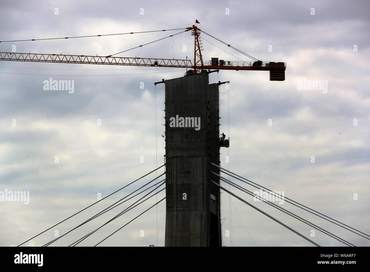 Chinese workers labor at the construction site of the stayed cable ...
