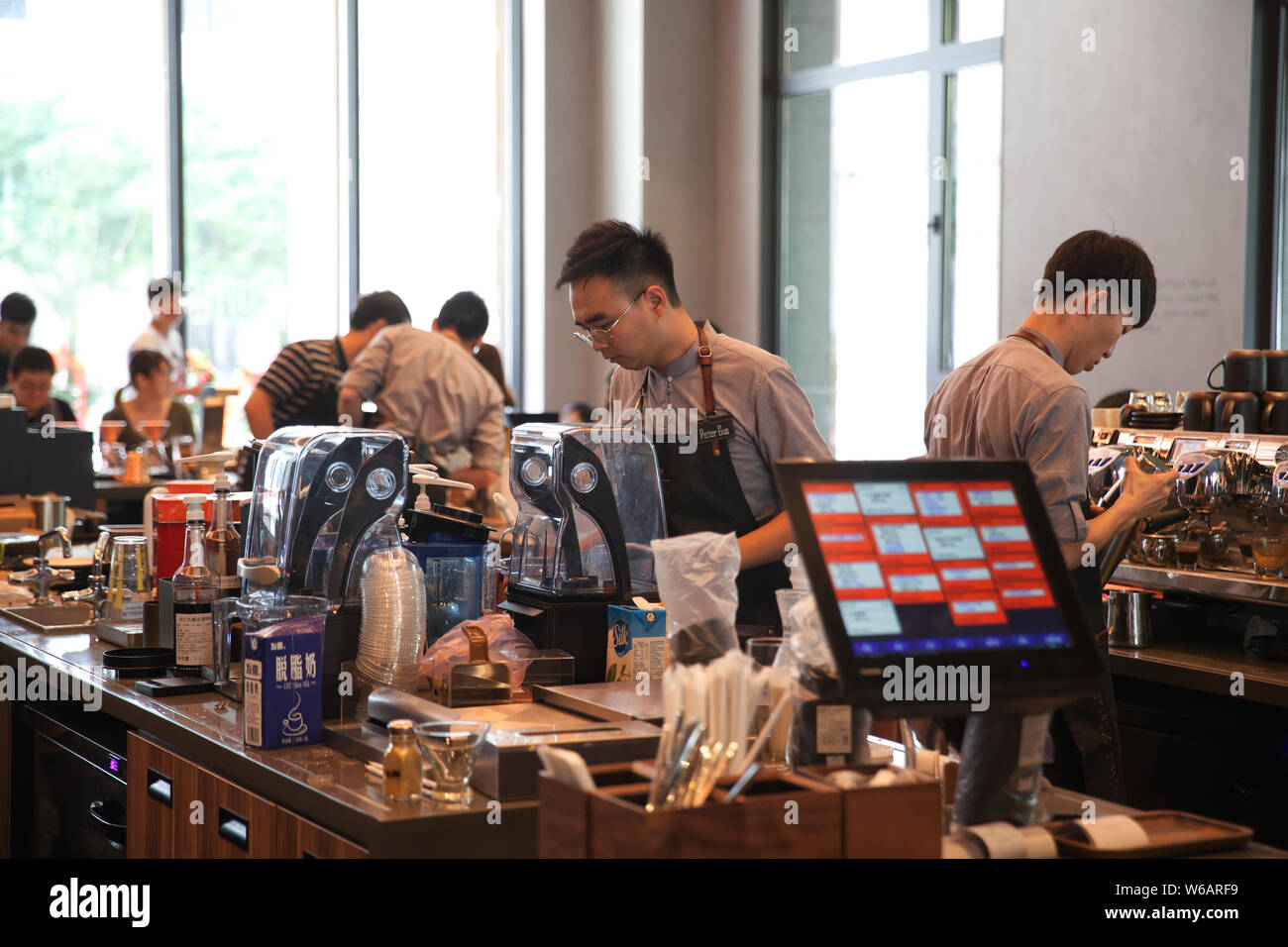 Chinese employees work at the newly-opened flagship store of Starbucks ...