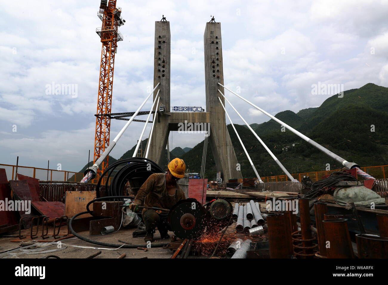 Chinese workers labor at the construction site of the stayed cable ...