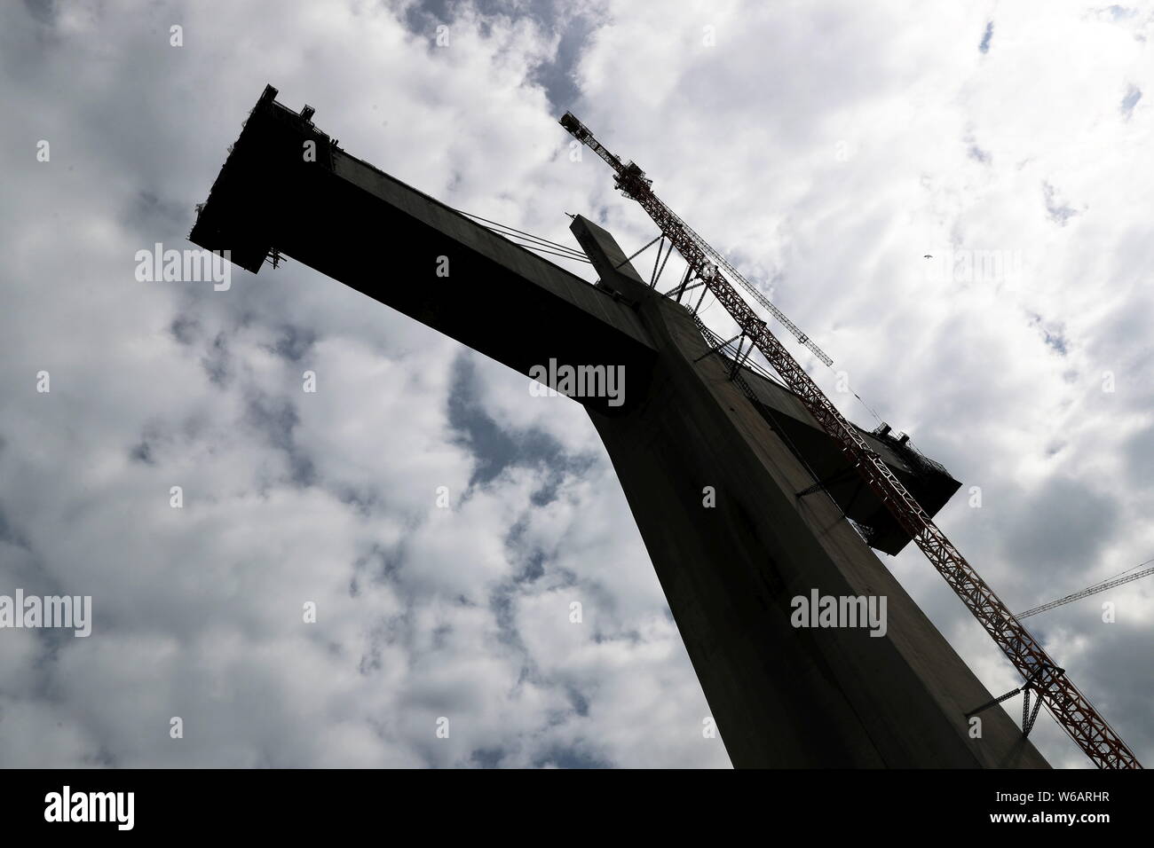 Chinese workers labor at the construction site of the stayed cable ...