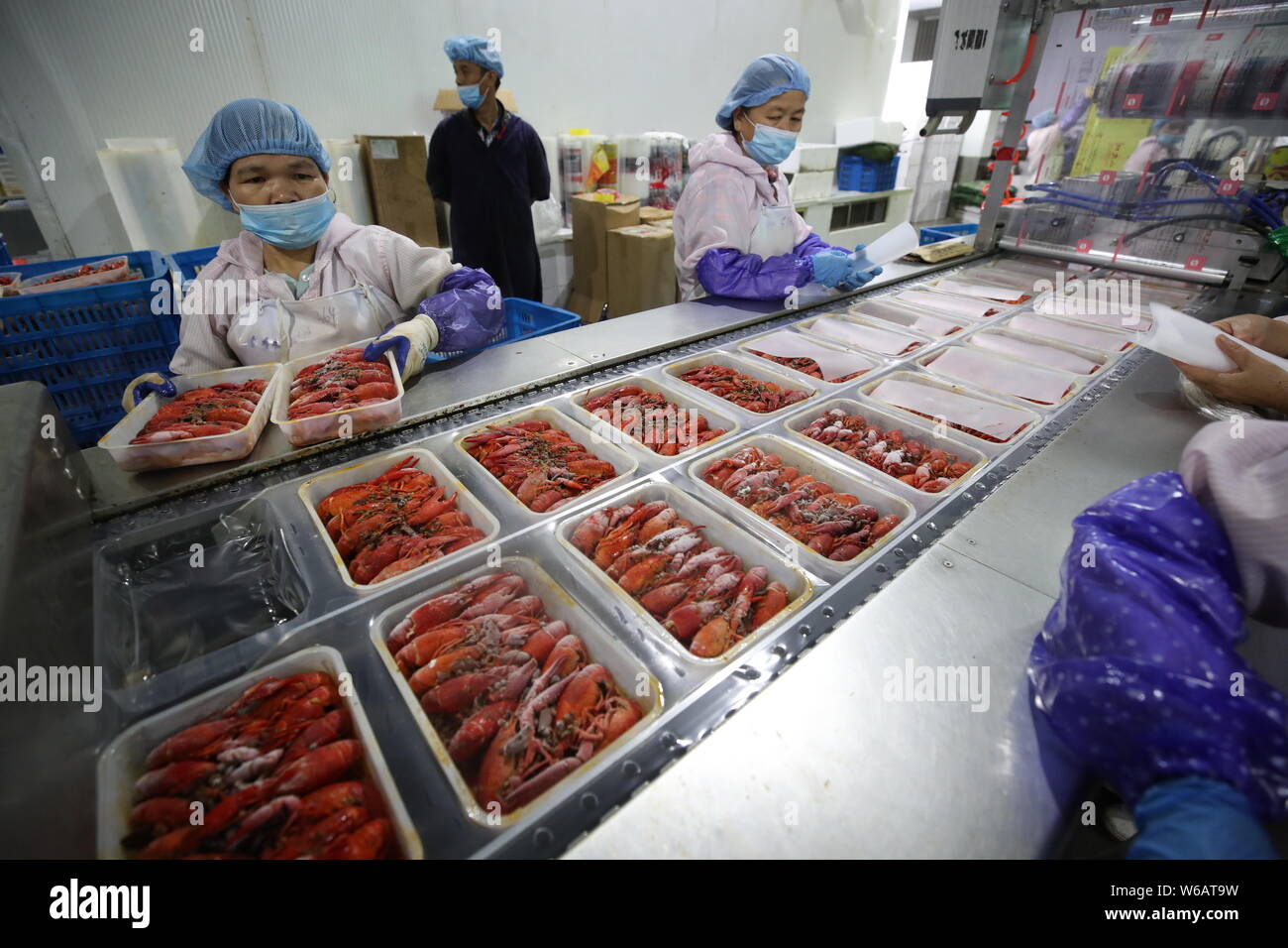 Chinese workers package crayfish to be served during the 2018 Russia ...