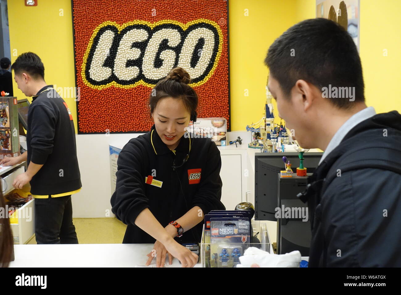 --FILE--Customers and employees are pictured at a Lego store in ...