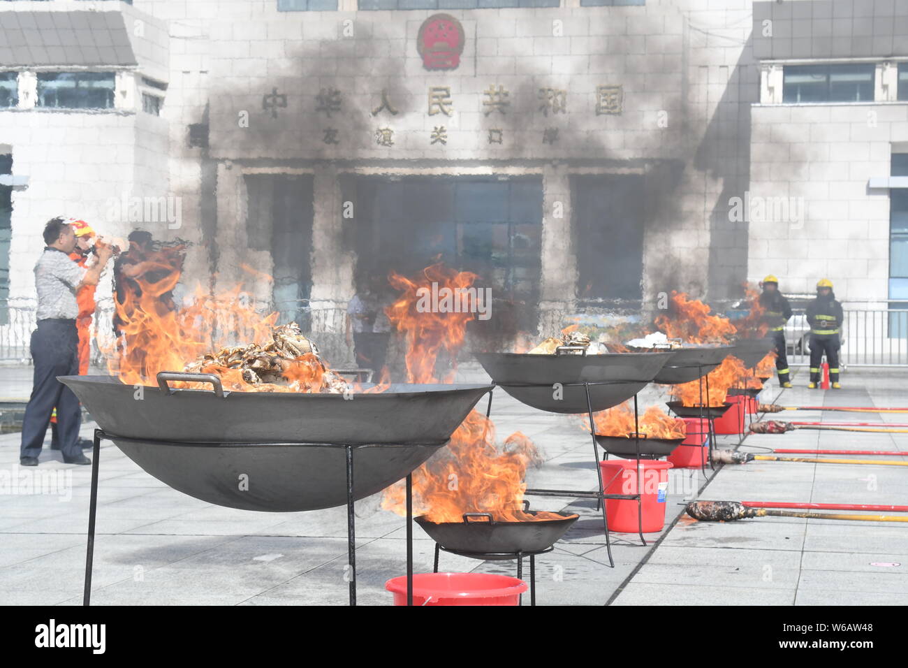 Drugs are being destroyed at the Youyiguan Pass at the border between ...