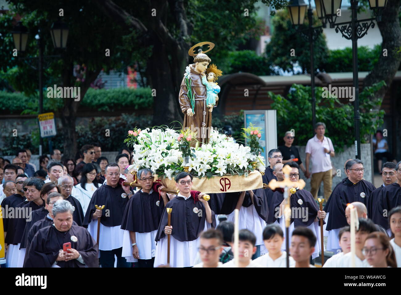 Members of a confraternity or brotherhood carry the statue of St ...
