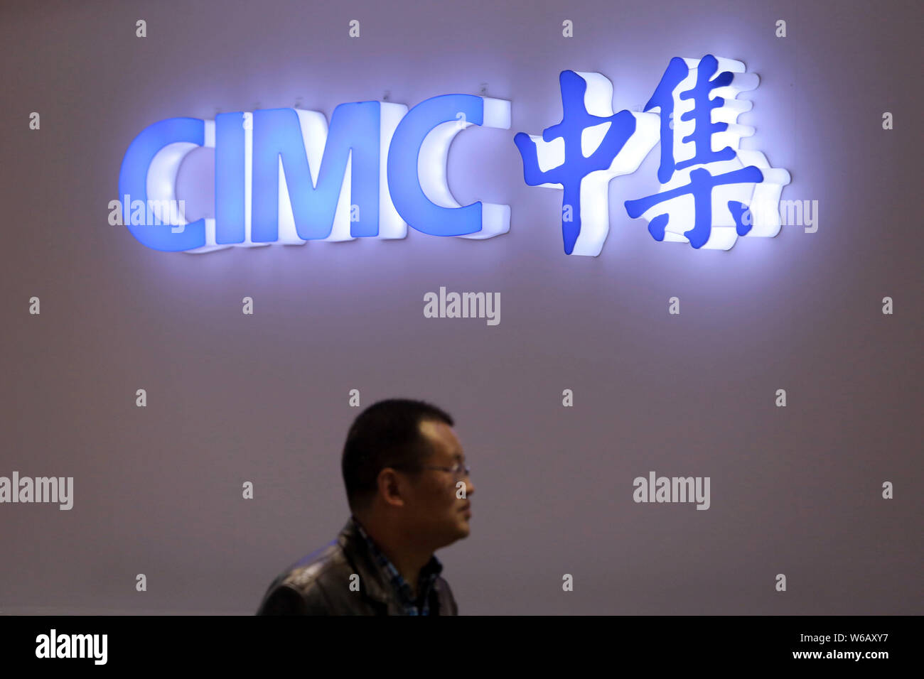 --FILE--A visitor walks past the stand of CIMC (China International ...