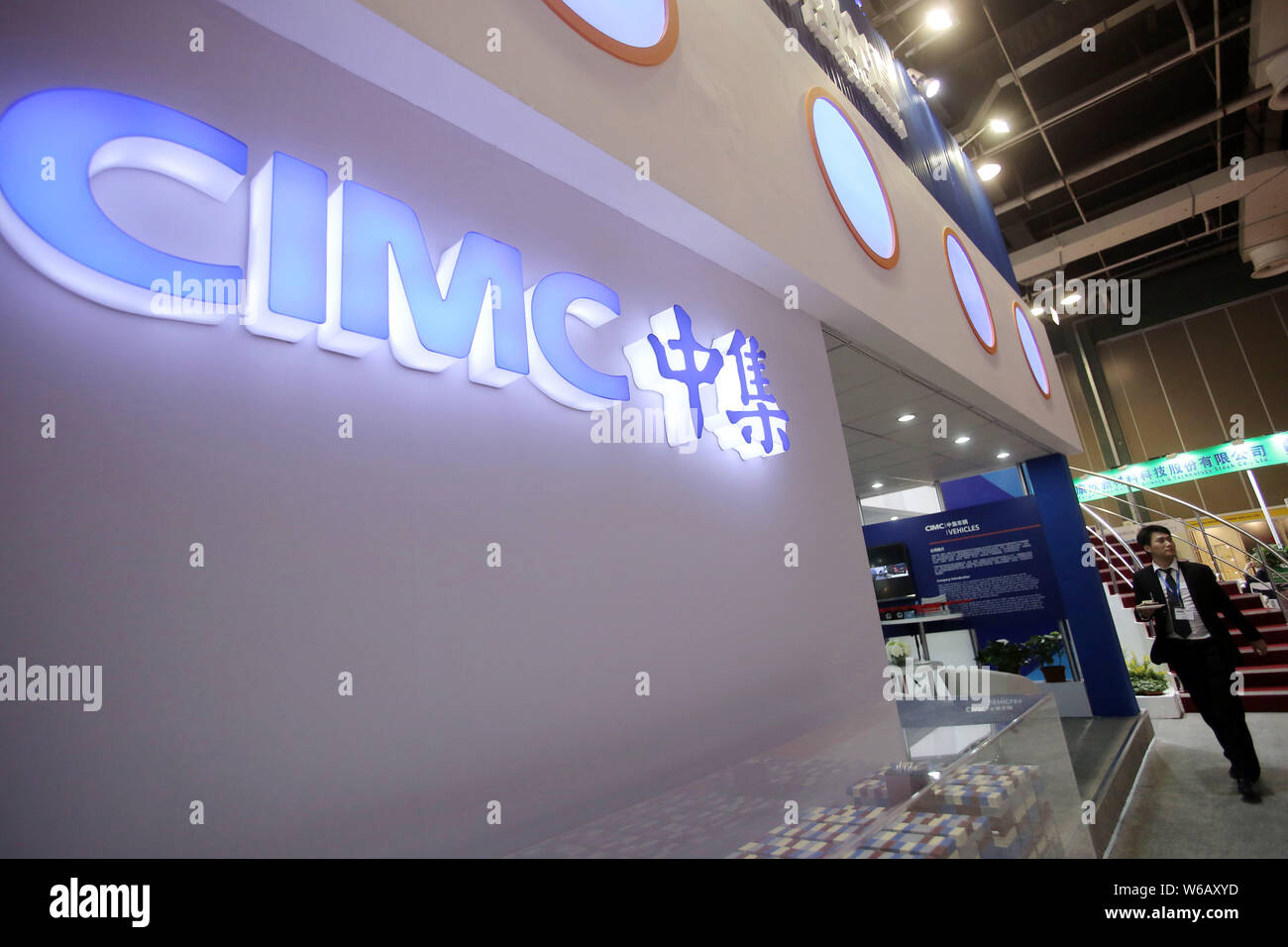--FILE--A visitor walks past the stand of CIMC (China International ...