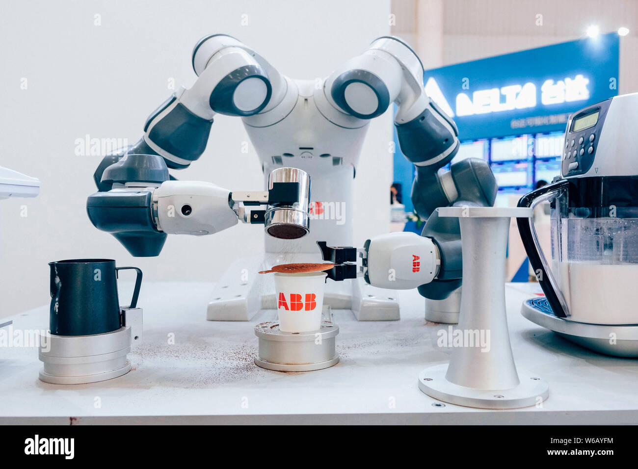 Robot arms of ABB Group make coffee during the Industrial Automation ...