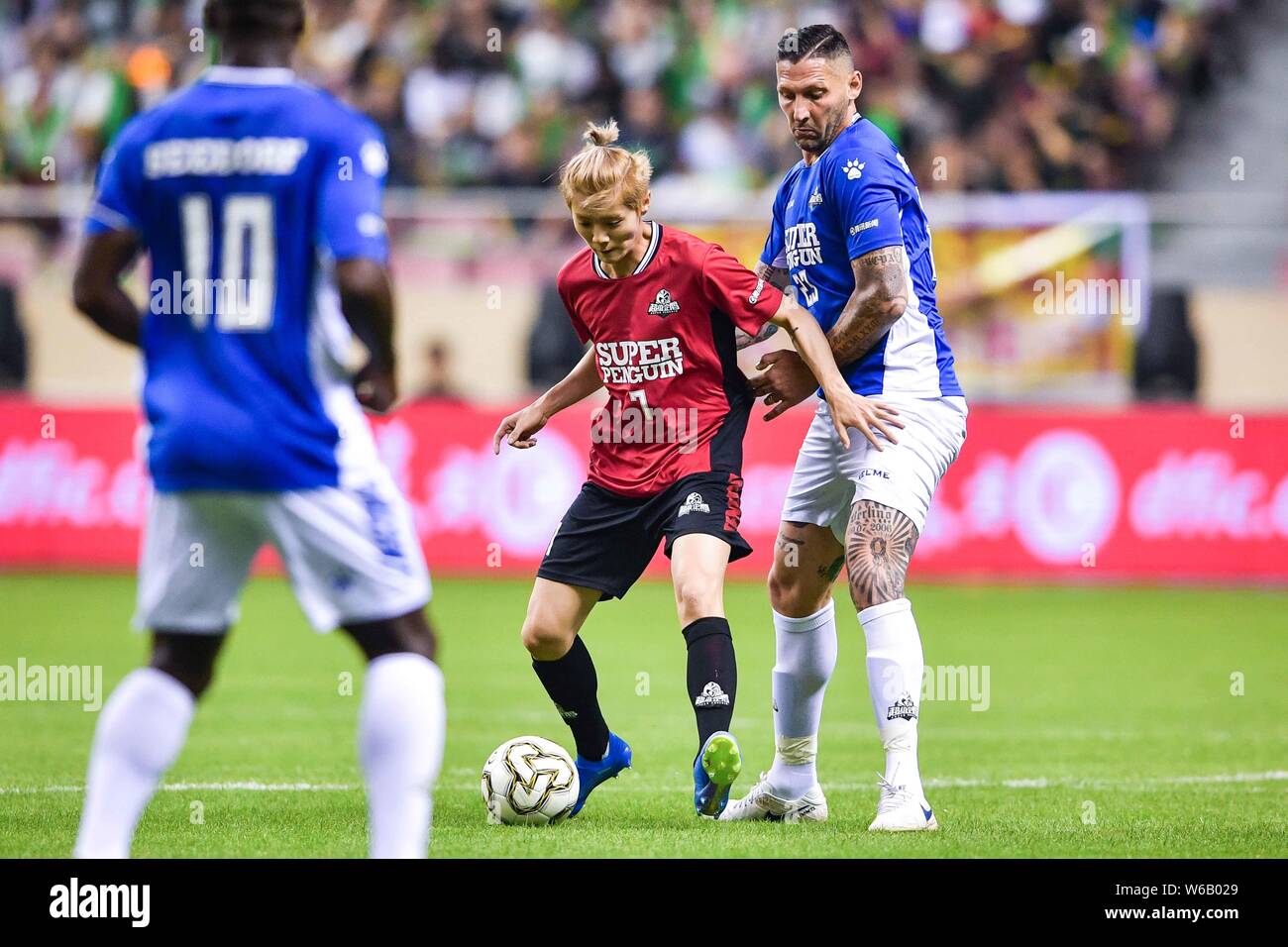 Chinese actor and singer Lu Han, center, of Chinese Celebrity dribbles ...