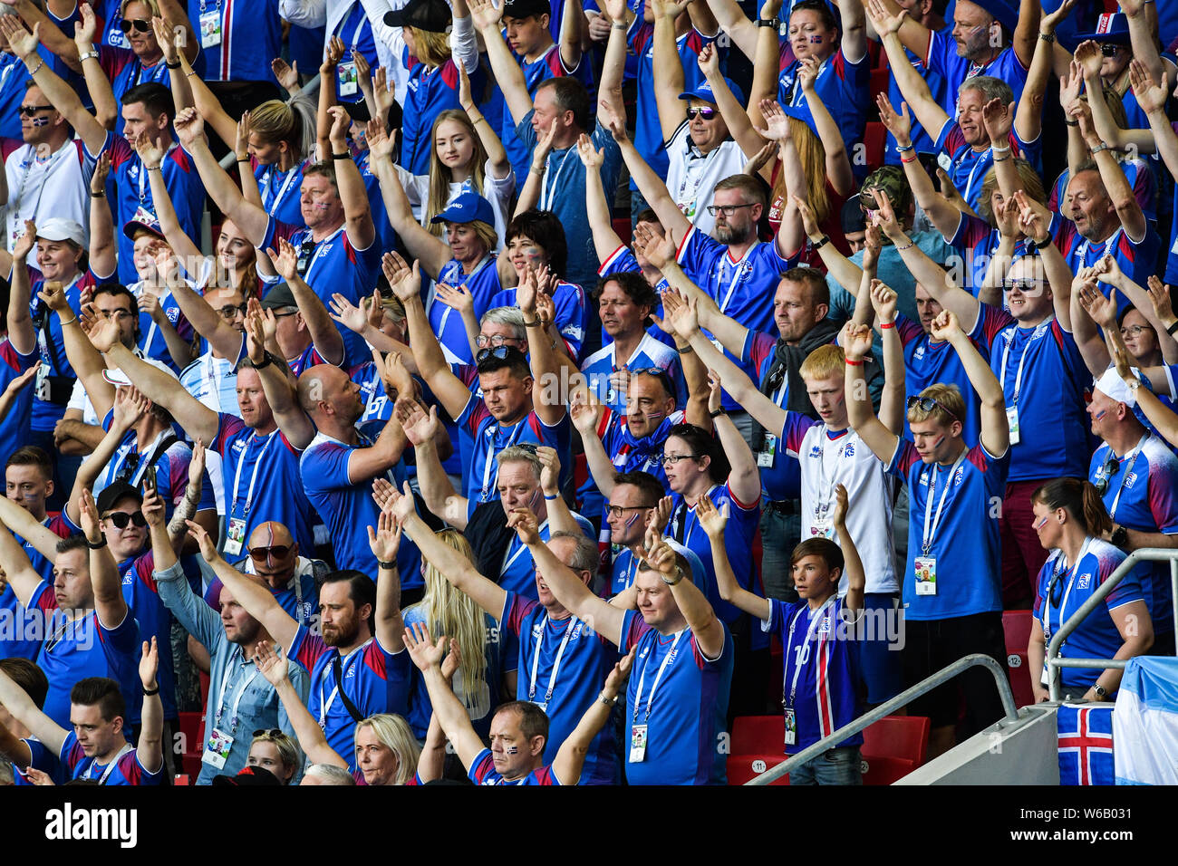 Football fans wave flags and shout slogans to show their support for ...