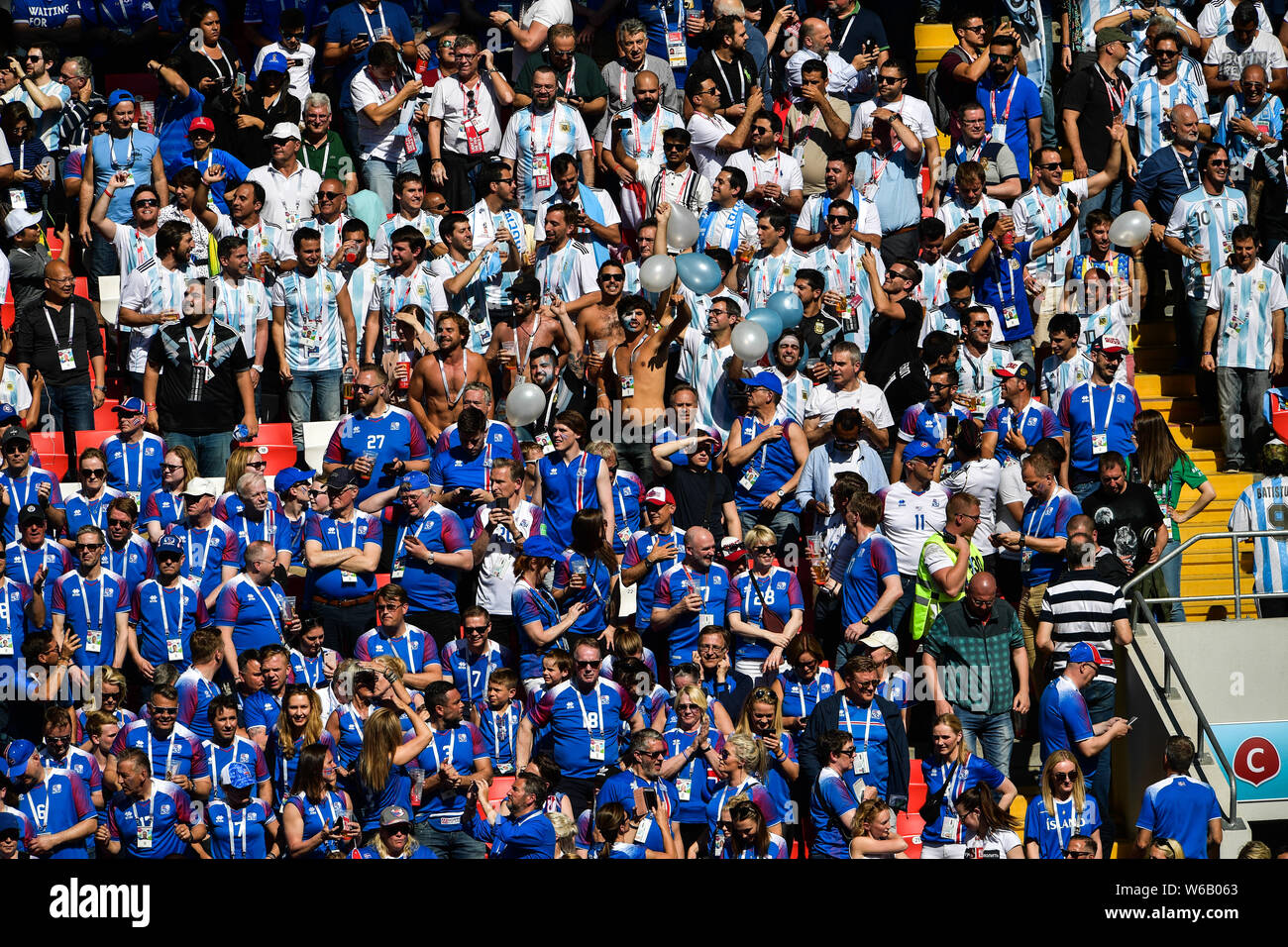 Football fans wave flags and shout slogans to show their support for ...