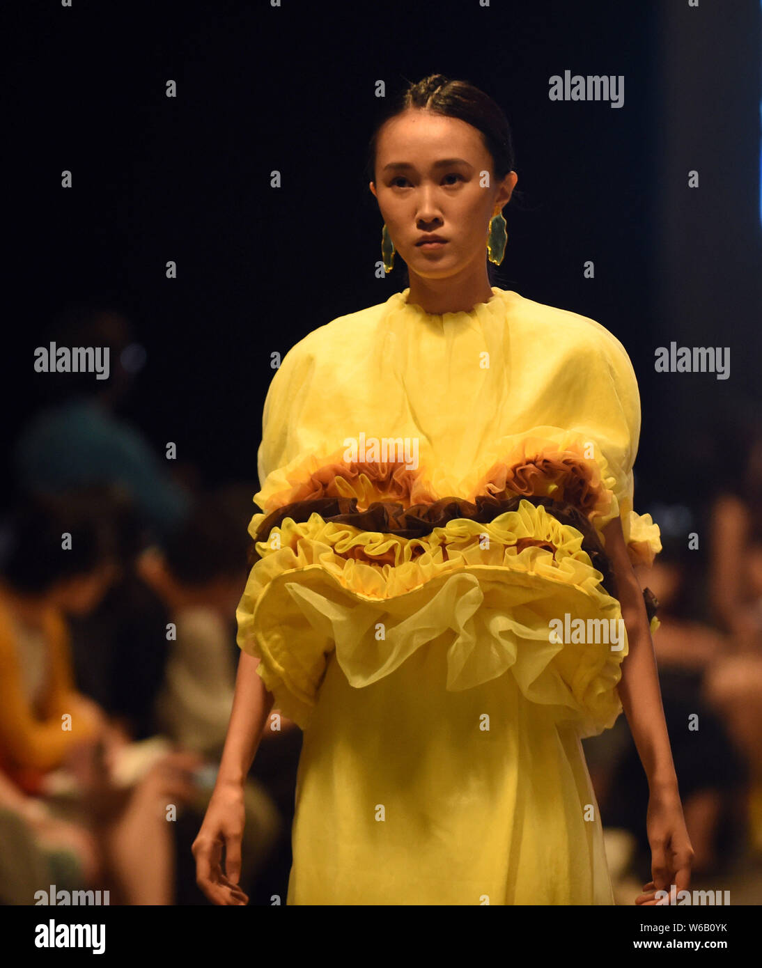 A model displays a new creation by a graduate during a fashion show for ...