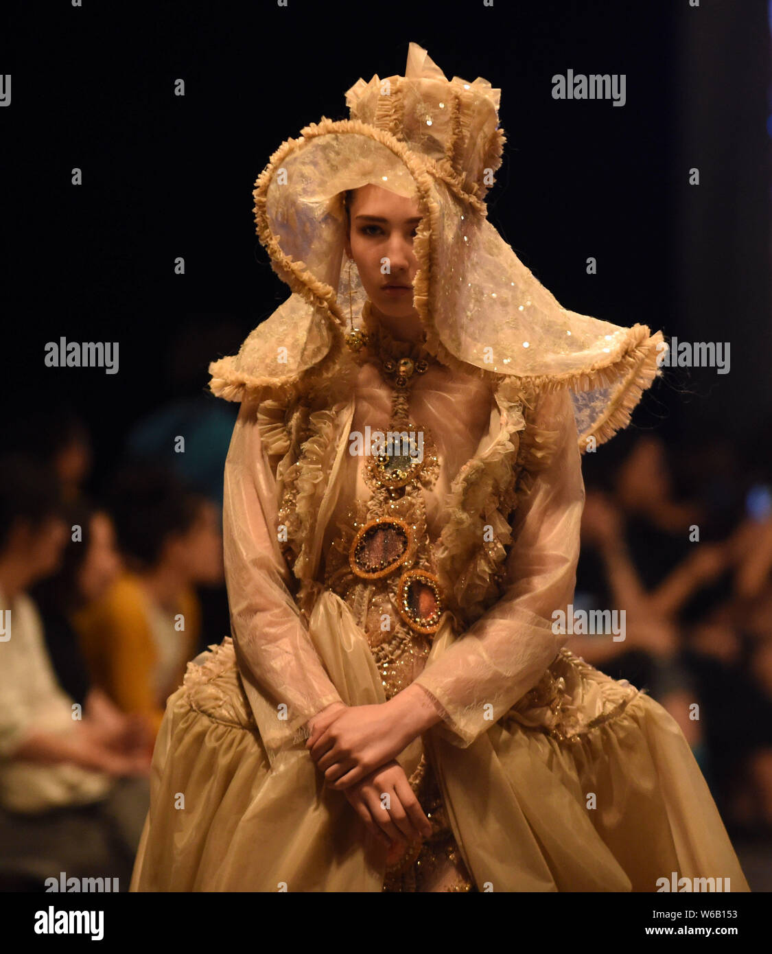 A model displays a new creation by a graduate during a fashion show for ...