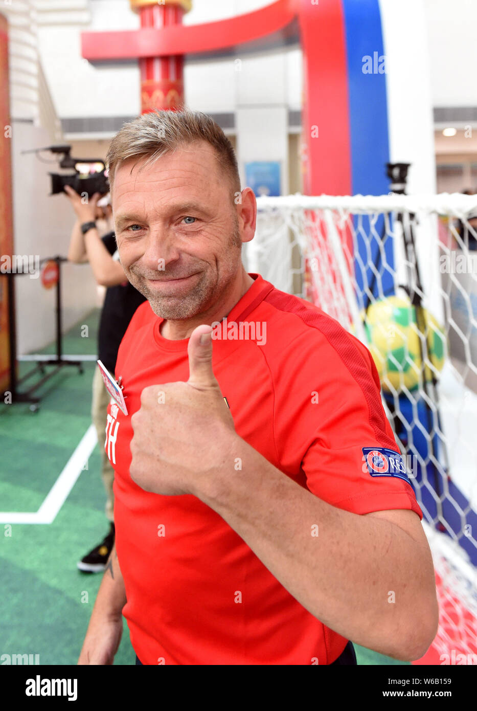 German former football player Thomas Hassler, in red, attends a ...