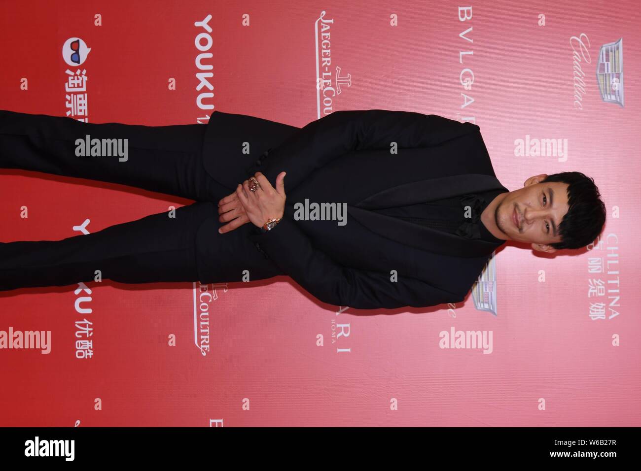 Taiwanese actor Zhang Zhen poses as he arrives on the red carpet for ...