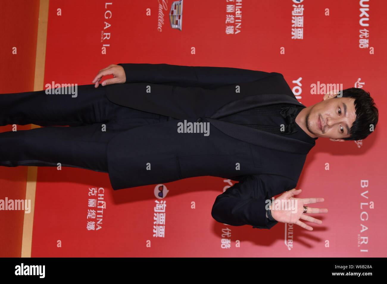 Taiwanese actor Zhang Zhen poses as he arrives on the red carpet for ...