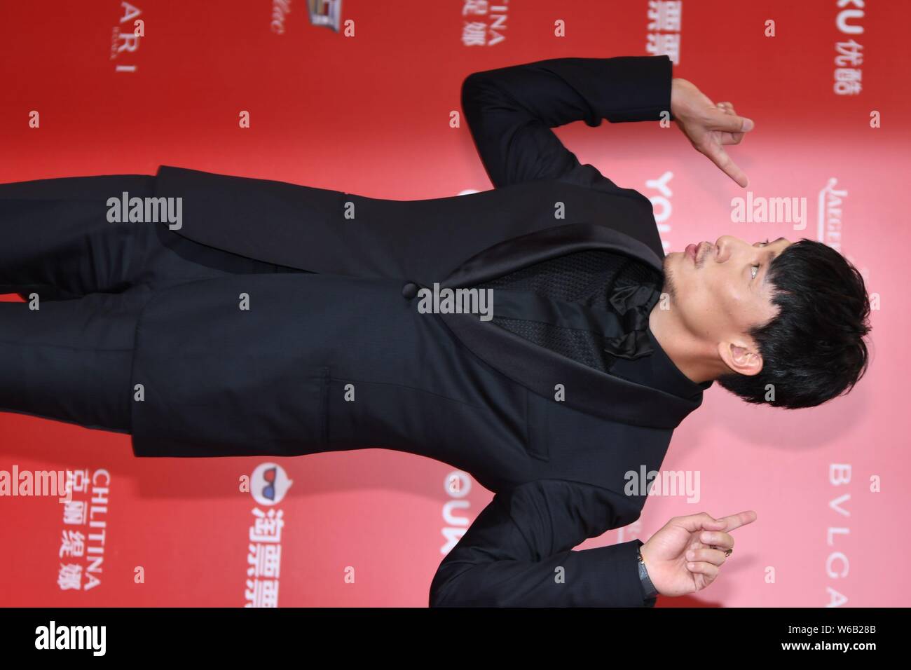 Taiwanese actor Zhang Zhen poses as he arrives on the red carpet for ...