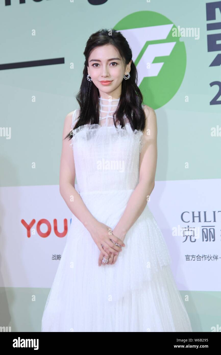 Hong Kong actress Angelababy poses as she arrives on the red carpet for the closing ceremony of ...