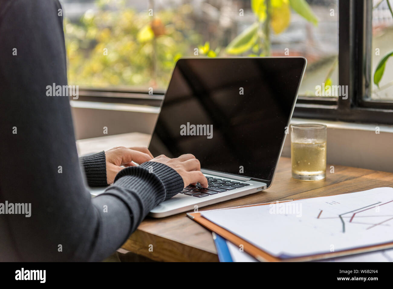 Woman hands typing laptop keyboard at workplace next to window Stock ...