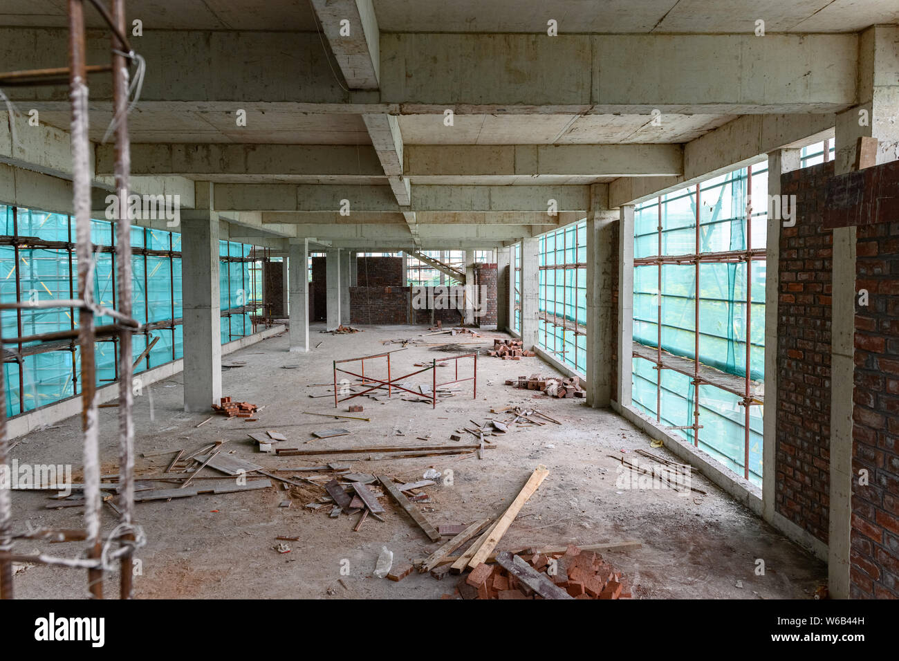 inside of an unfiinshed building with protection scaffolding and ...