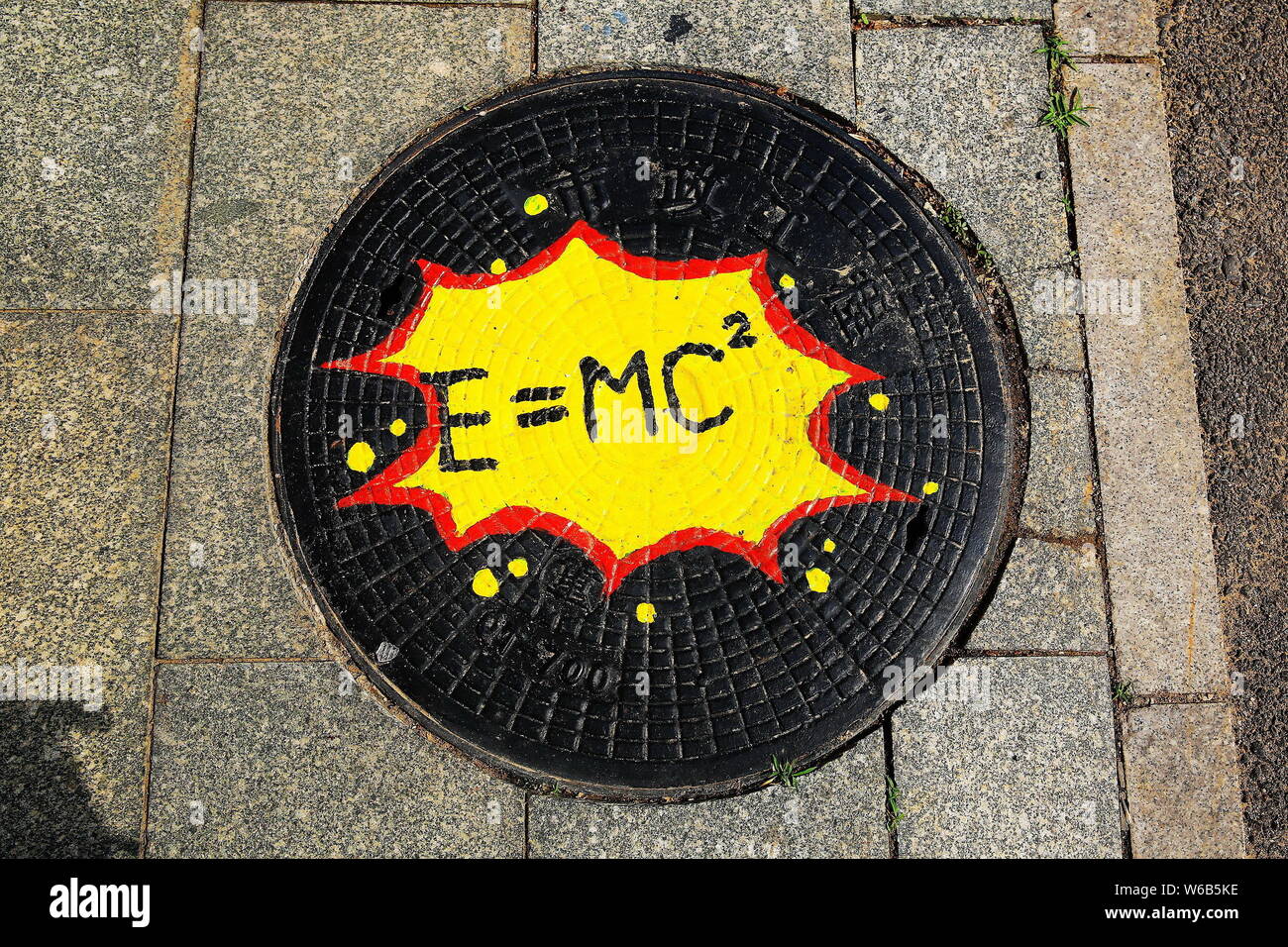 A manhole cover is decorated with special cartoon graffiti ...