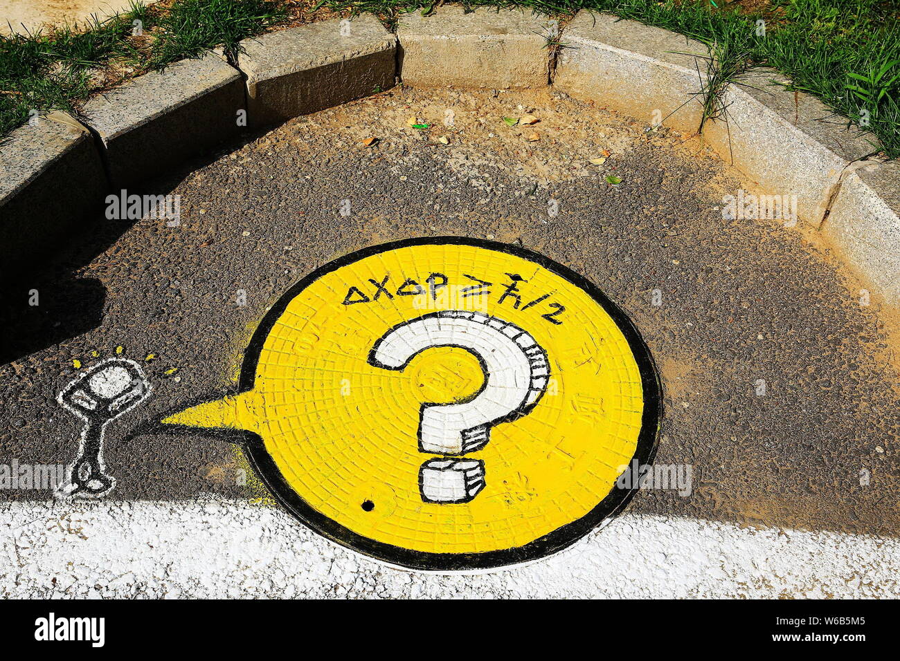 A manhole cover is decorated with special cartoon graffiti ...