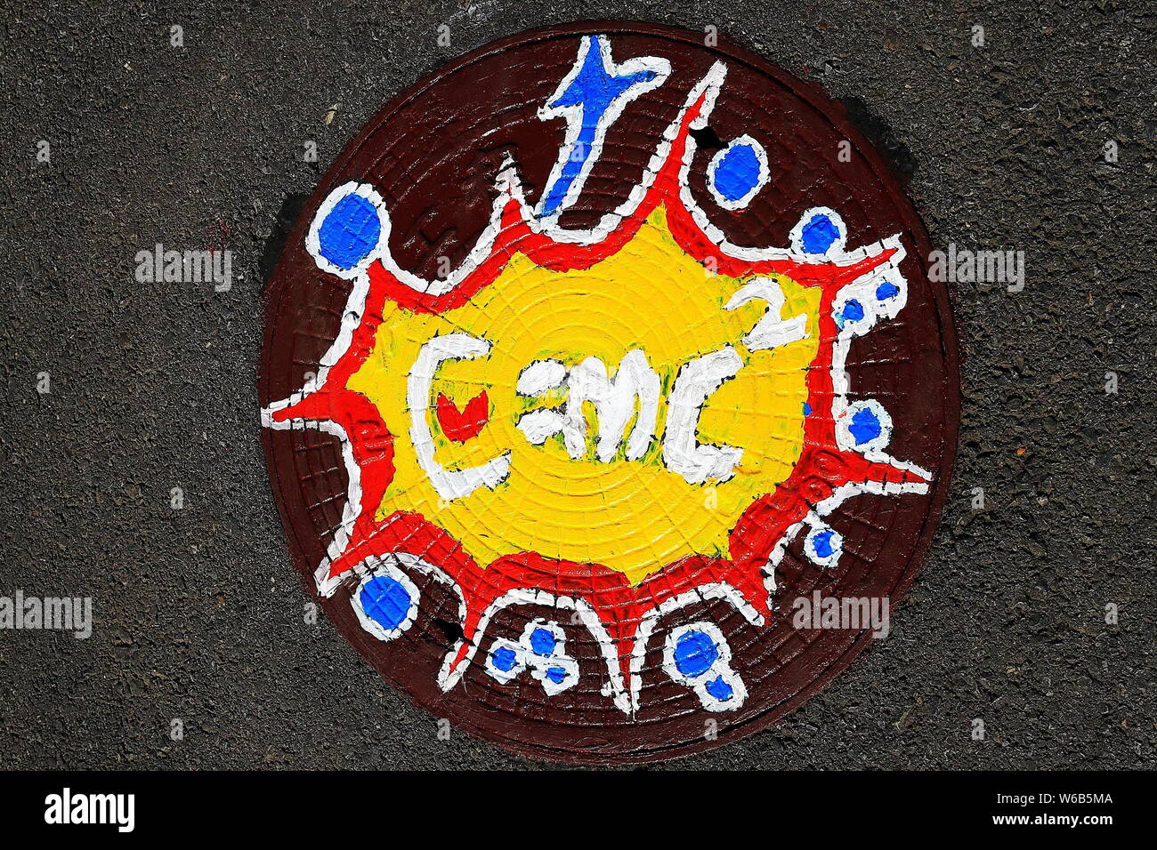 A manhole cover is decorated with special cartoon graffiti ...