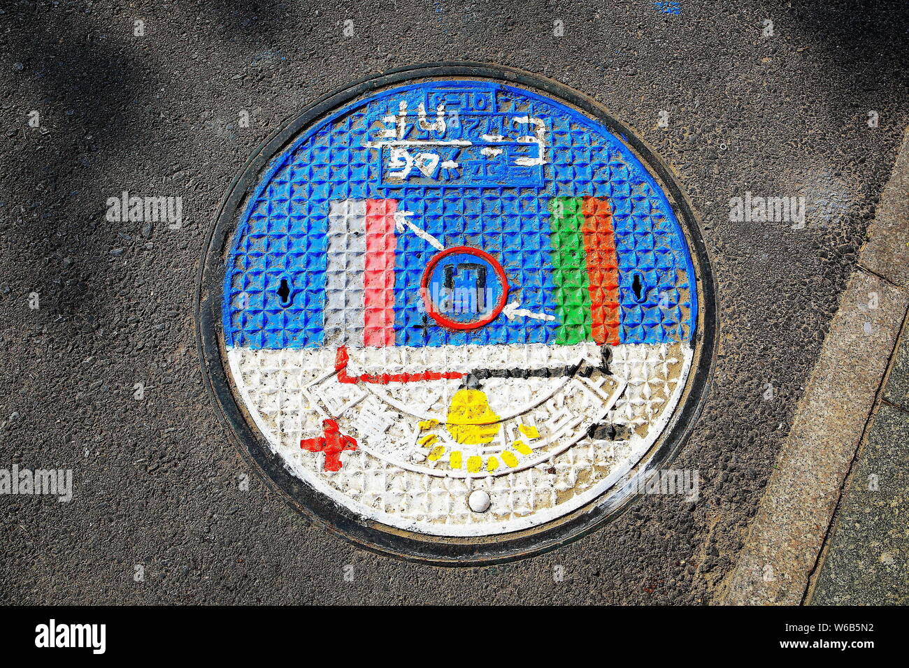A manhole cover is decorated with special cartoon graffiti ...
