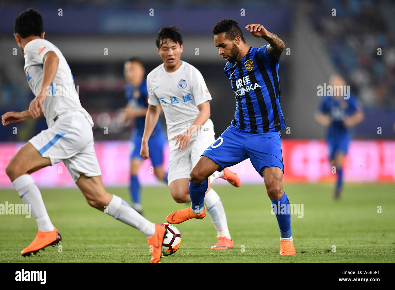 Brazilian football player Alex Teixeira, right, of Jiangsu Suning kicks ...