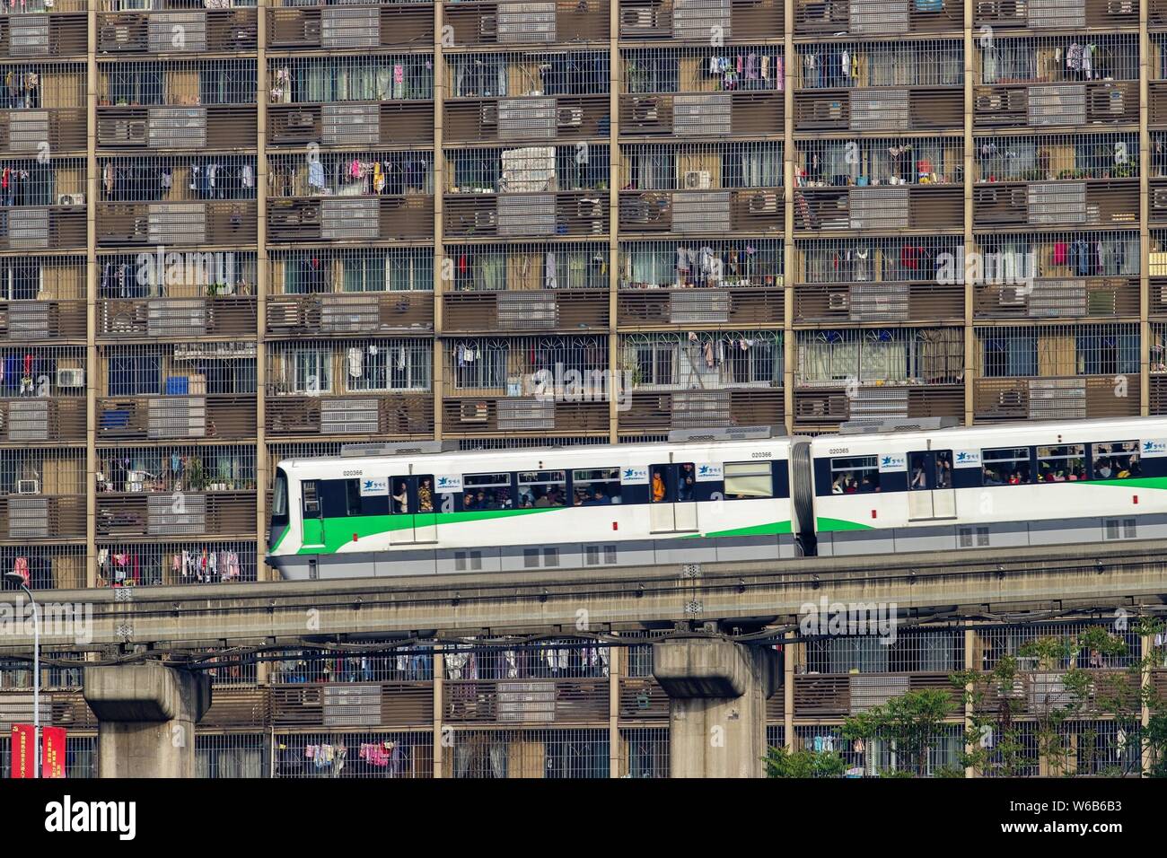 A monorail train of Chongqing Light Rail runs through high-rise ...