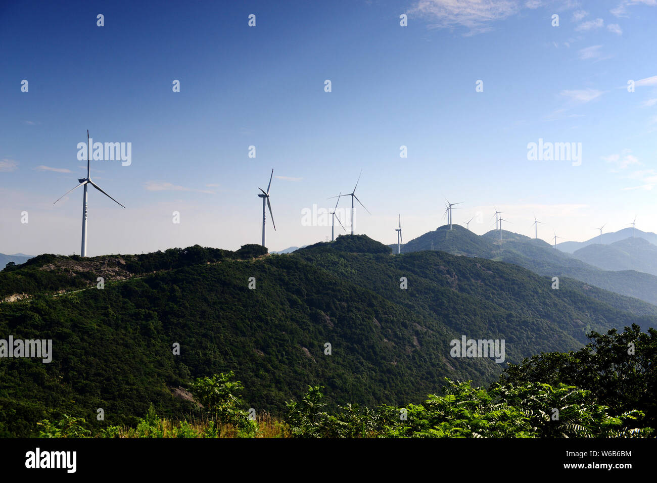 --FILE--Wind turbines whirl to generate electricity at a wind farm in ...