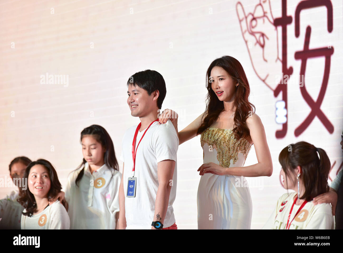 Taiwanese model and actress Lin Chi-ling gives a fan massages during a promotional event for ...