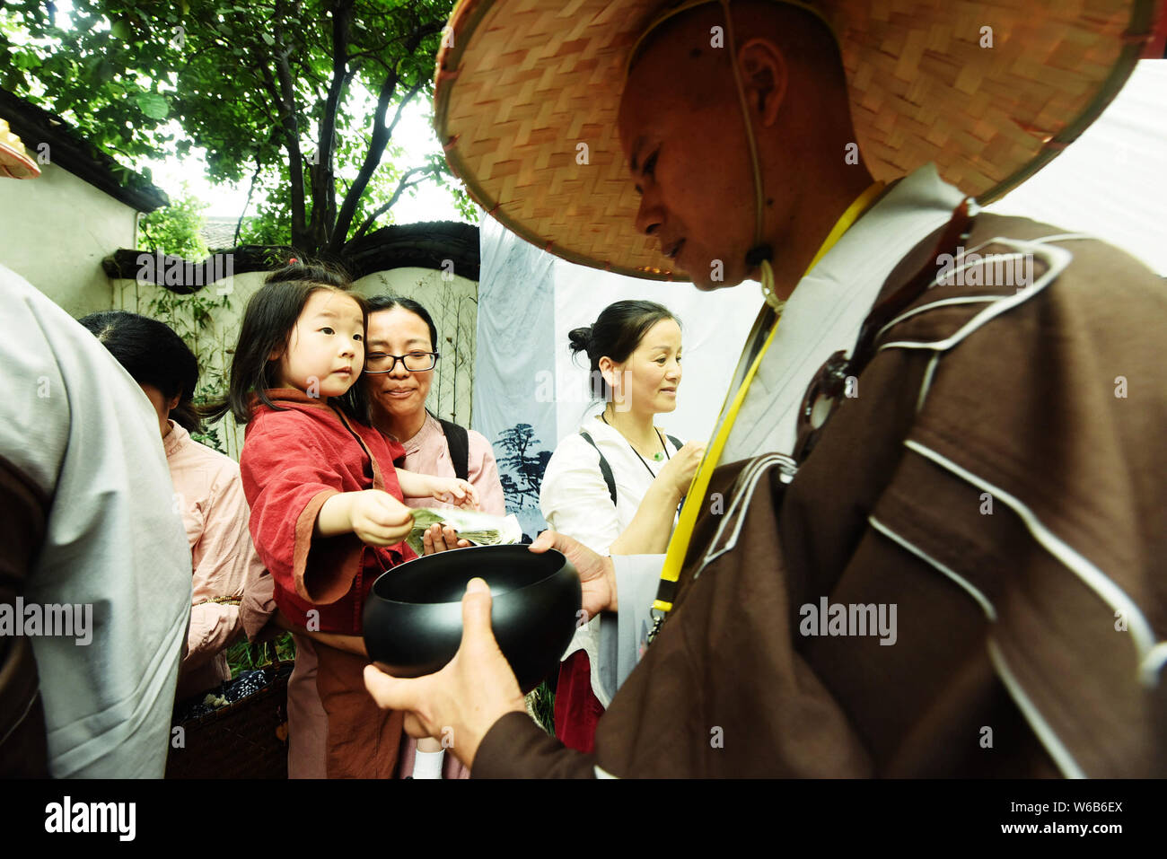 Chinese Buddhist monks holding alms bowls to receive donation from ...