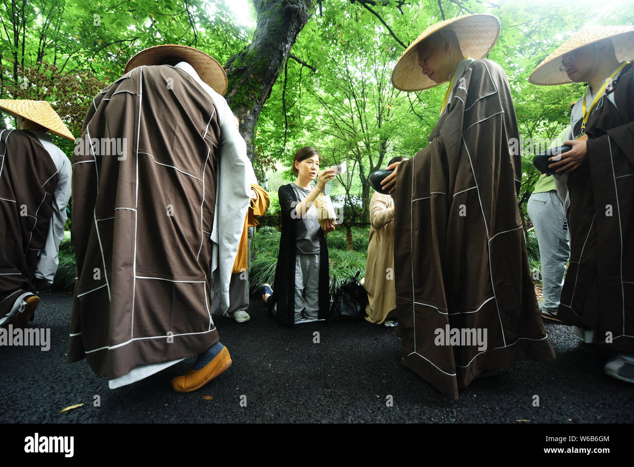 Chinese Buddhist monks holding alms bowls to receive donation from ...