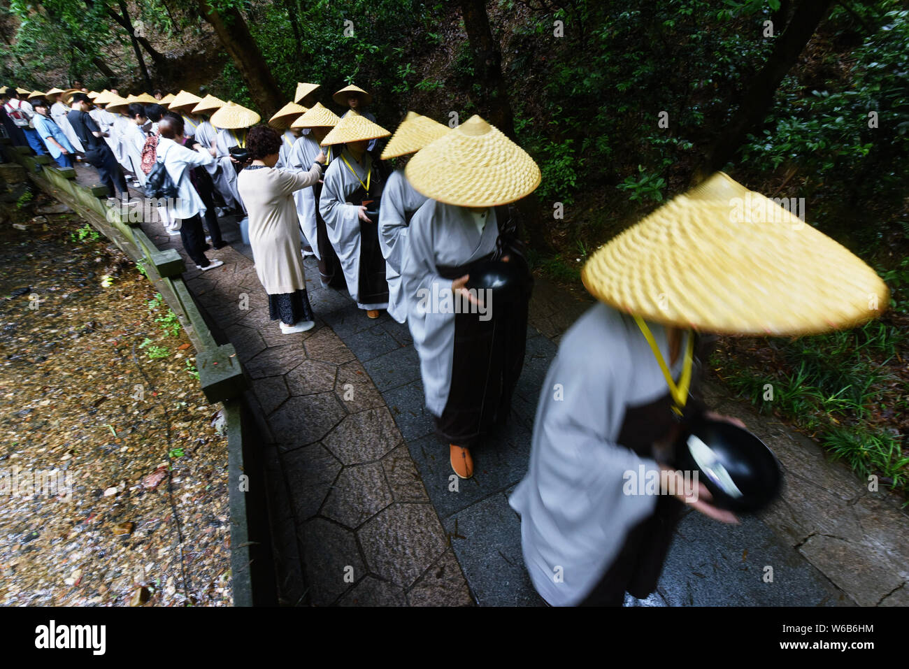 Chinese Buddhist monks holding alms bowls to receive donation from ...