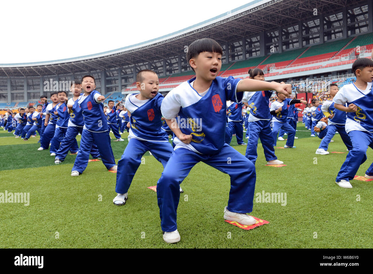 Chinese children perform kungfu with a master in an attempt to set a ...