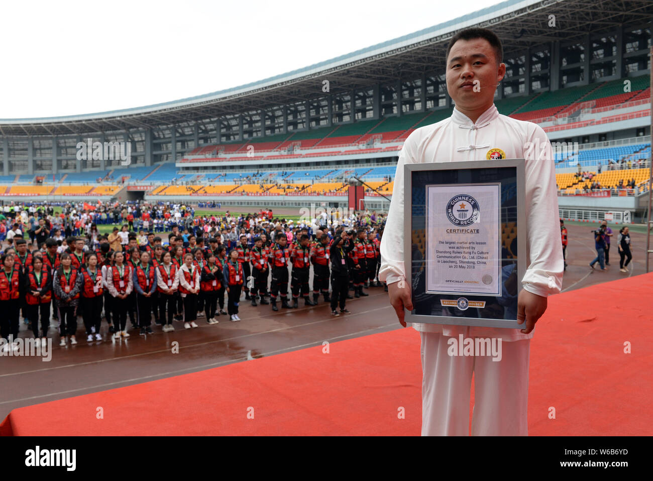 A kungfu master poses with the Guinness World Record certificate for ...