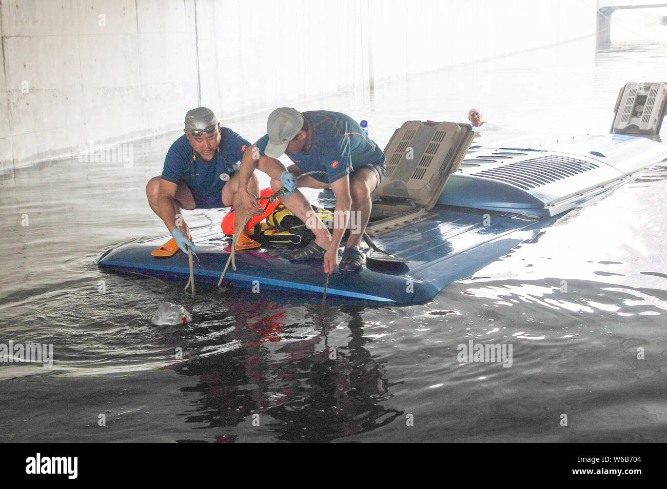 Members of rescue team from Zhengzhou Red Cross conduct an underwater ...