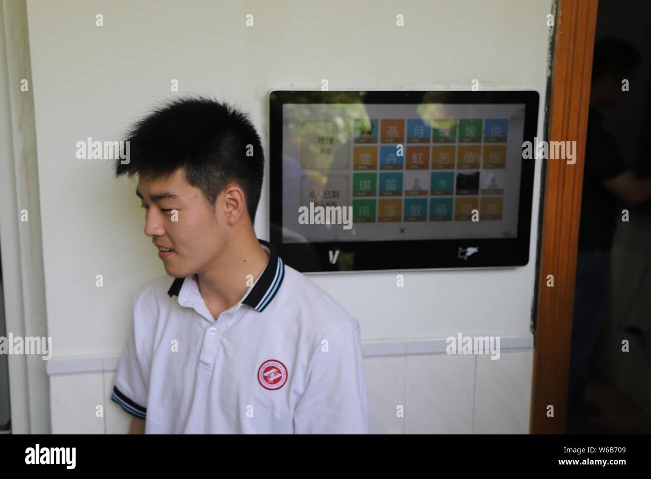 A student registers his attendance by face recognition outside a ...