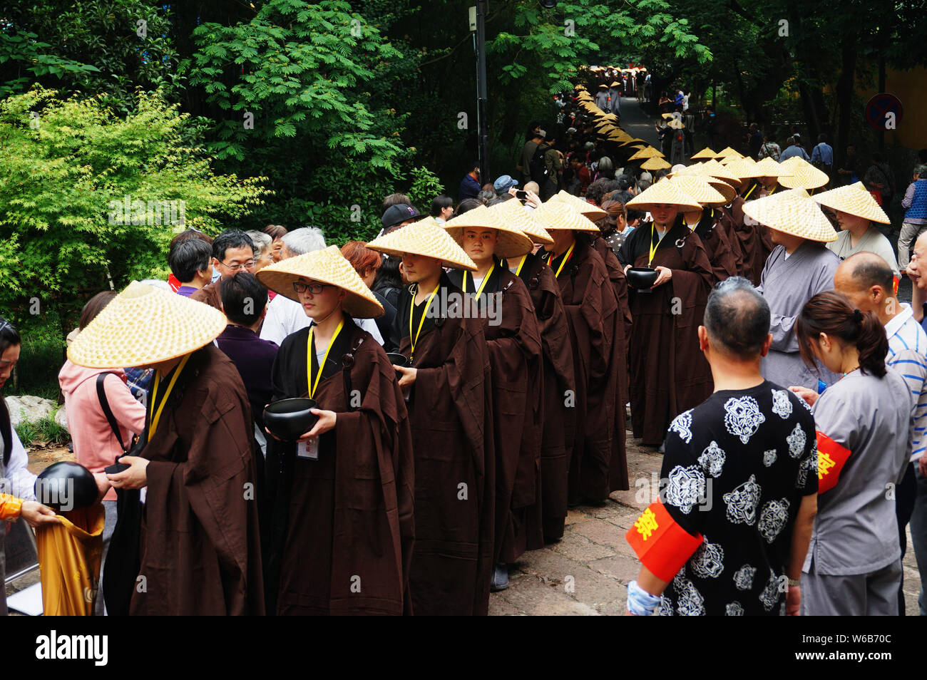 Chinese Buddhist monks holding alms bowls to receive donation from ...