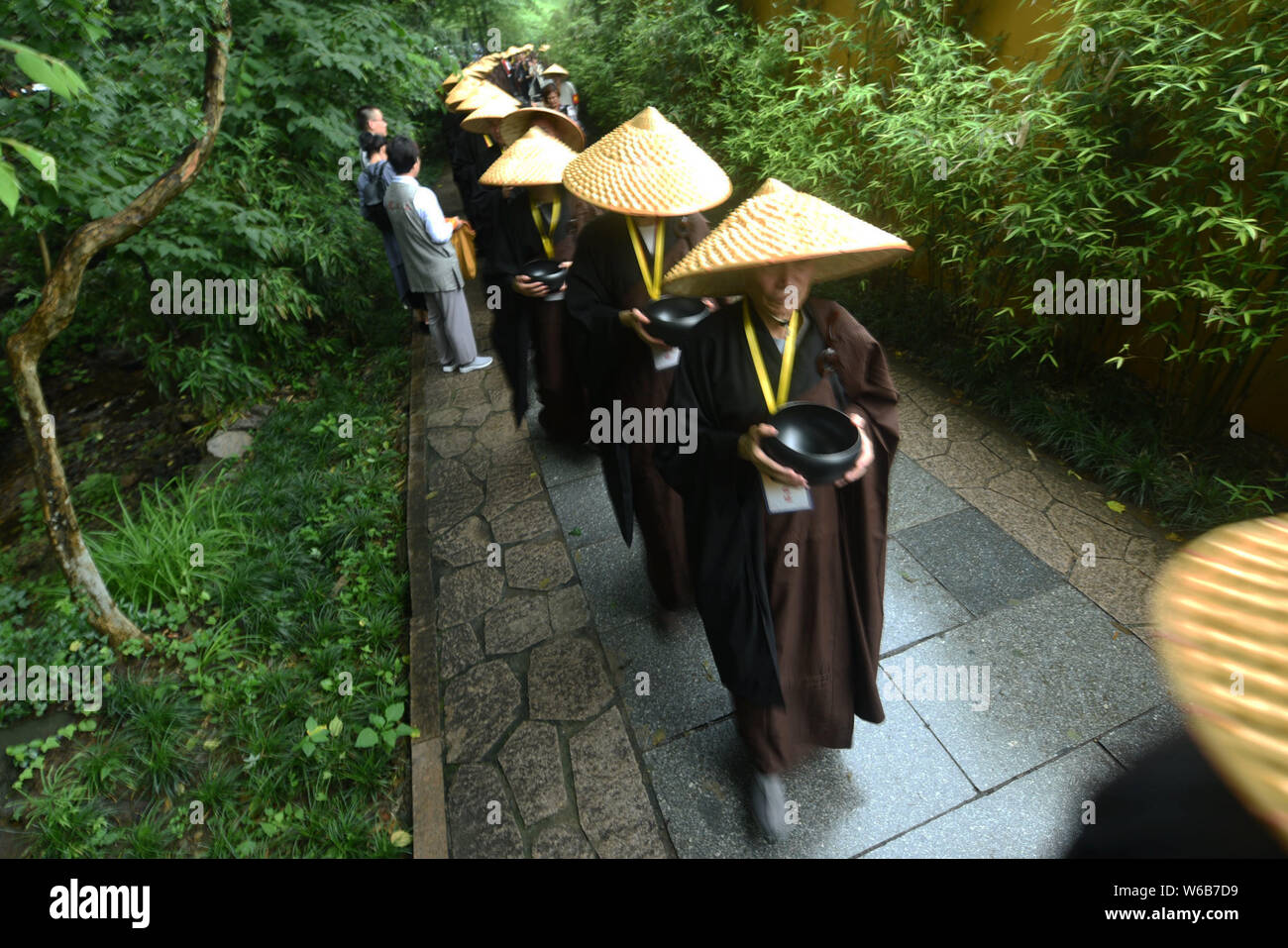 Chinese Buddhist monks holding alms bowls to receive donation from ...