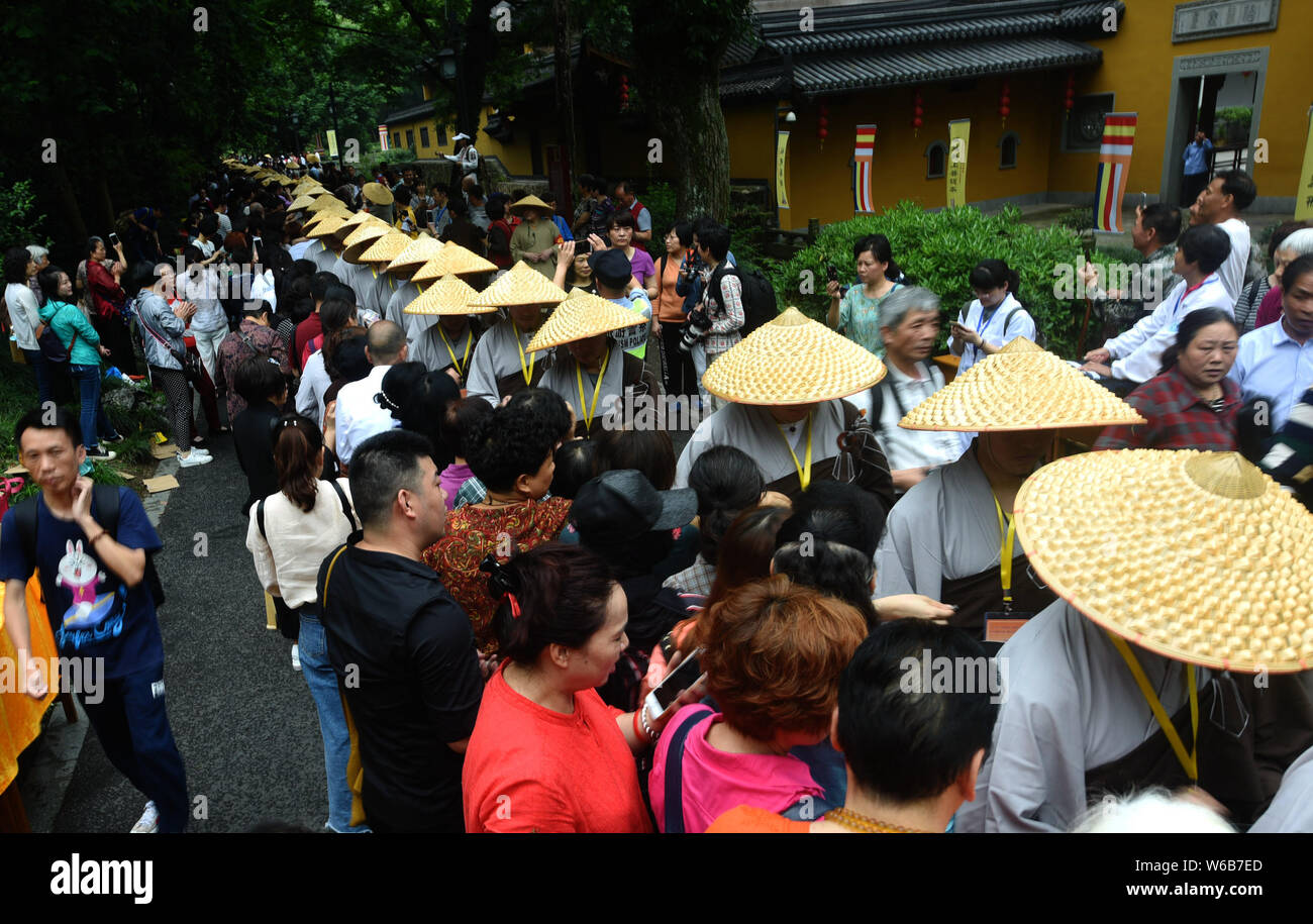 Chinese Buddhist monks holding alms bowls to receive donation from ...