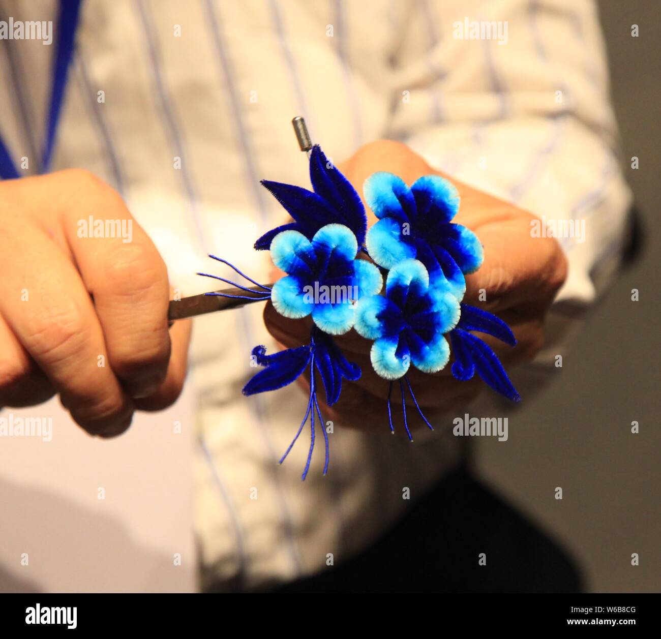 64-year-old Chinese craftsman Zhao Shuxian makes velvet flowers at his ...