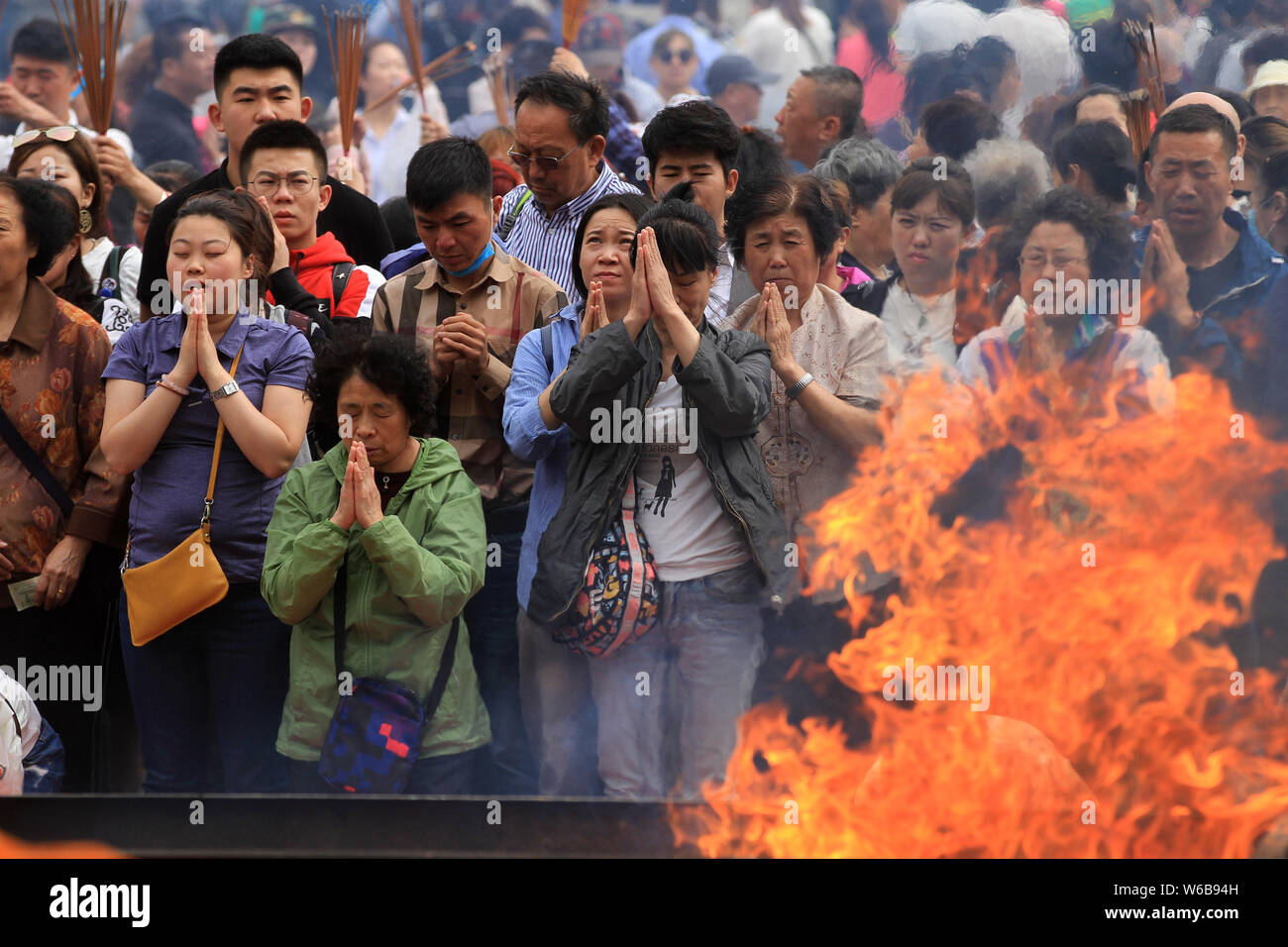 Chinese worshippers burn joss sticks (incenses) to celebrate the Buddha ...