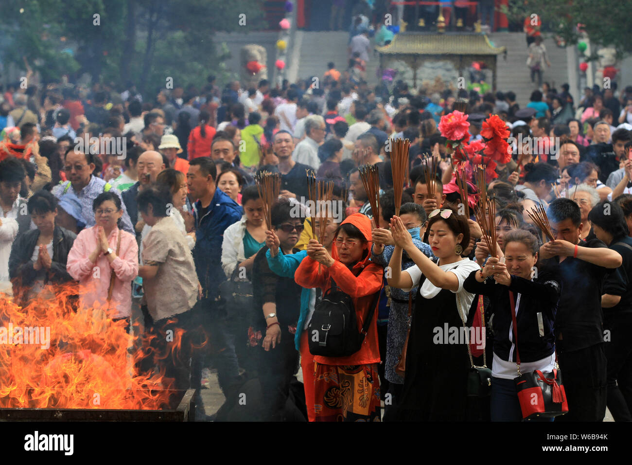 Chinese worshippers burn joss sticks (incenses) to celebrate the Buddha ...
